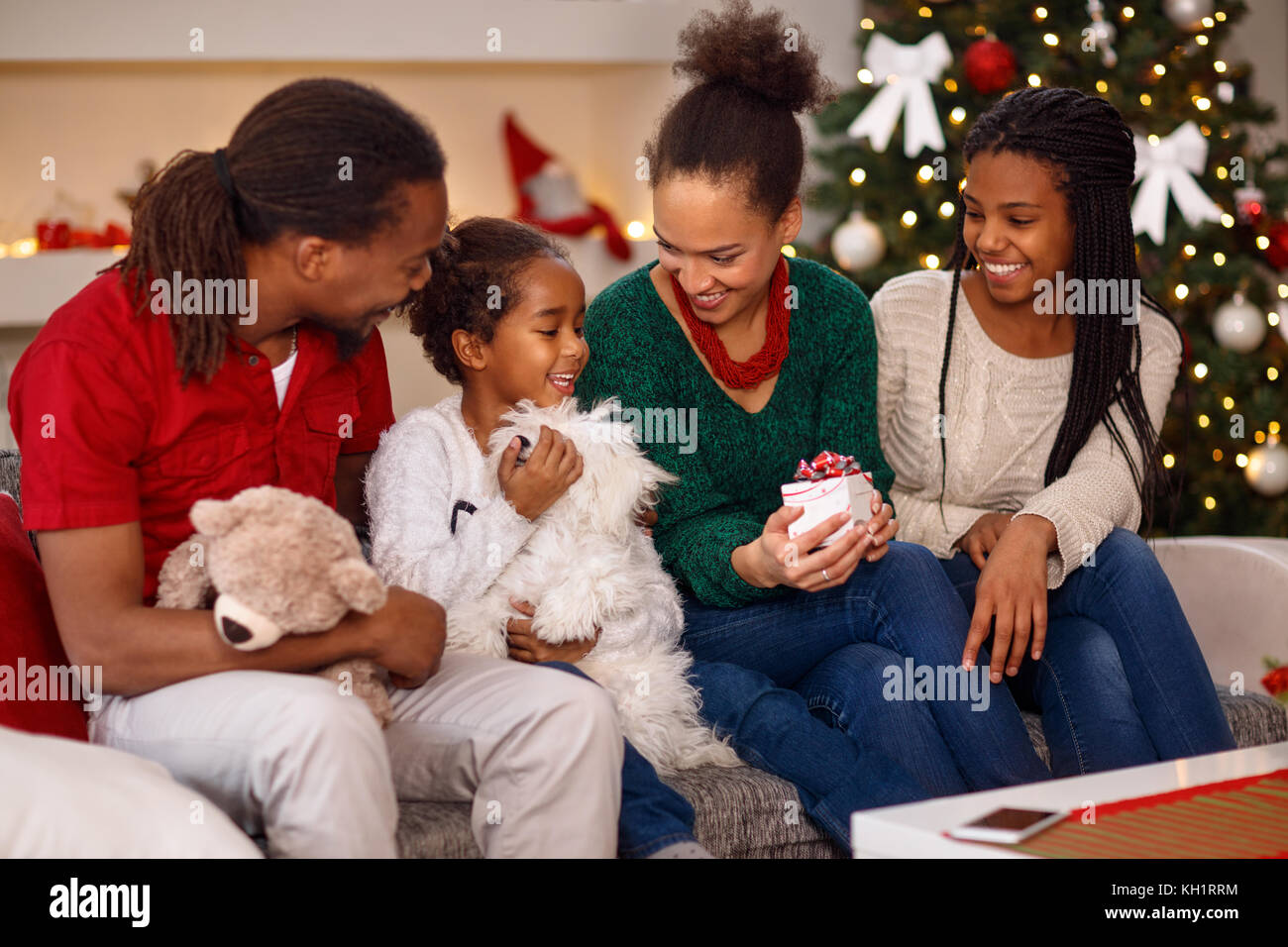 Family during the Christmas with presents Stock Photo - Alamy