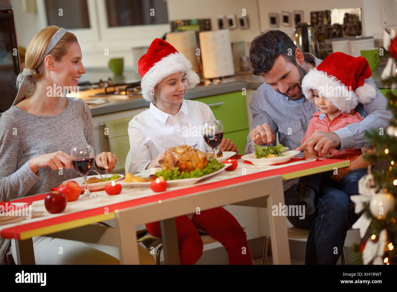 Smiling family eating traditional Christmas dinner Stock Photo - Alamy