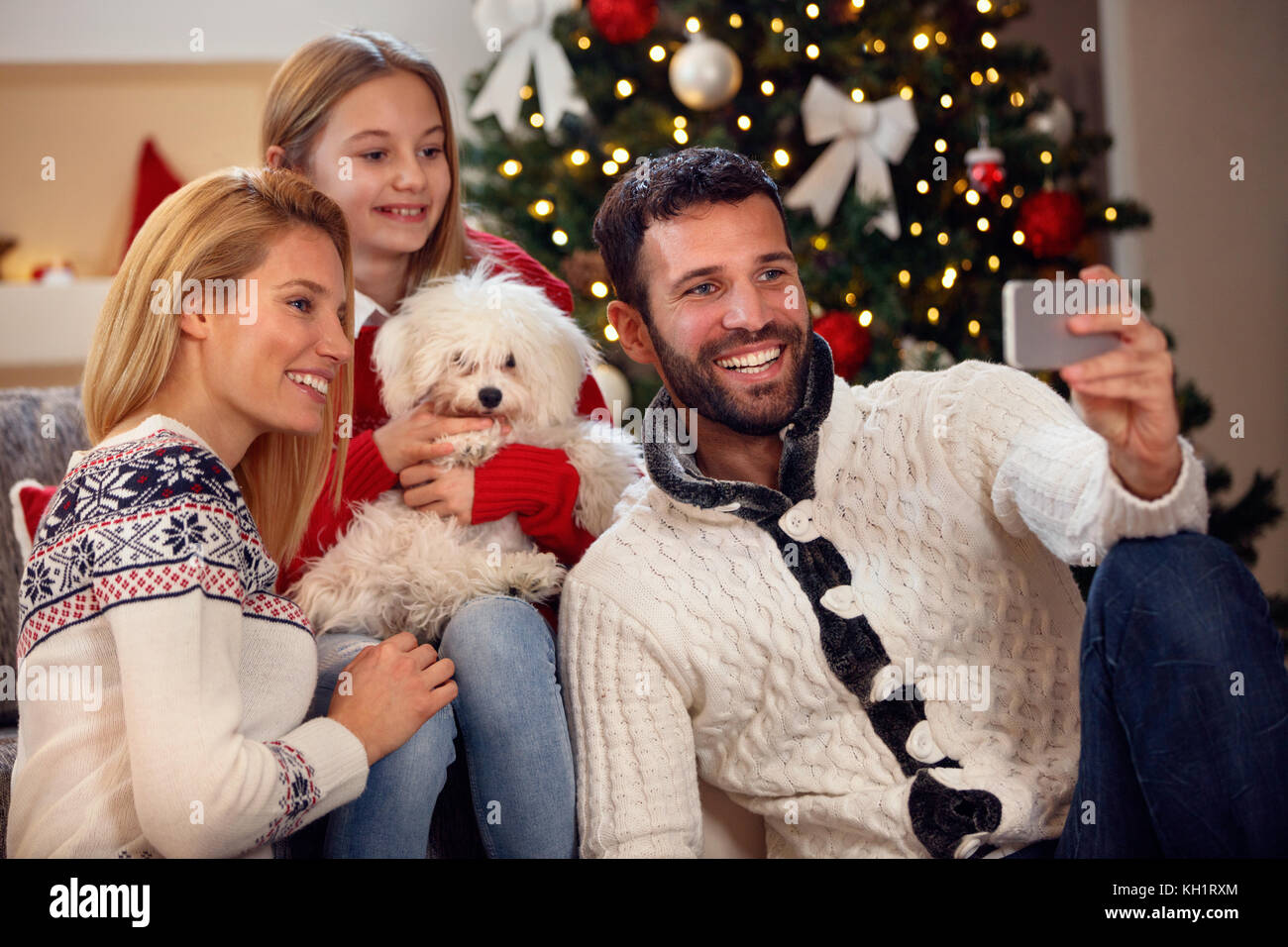 Christmas time family self-portrait- young smiling family Stock Photo ...