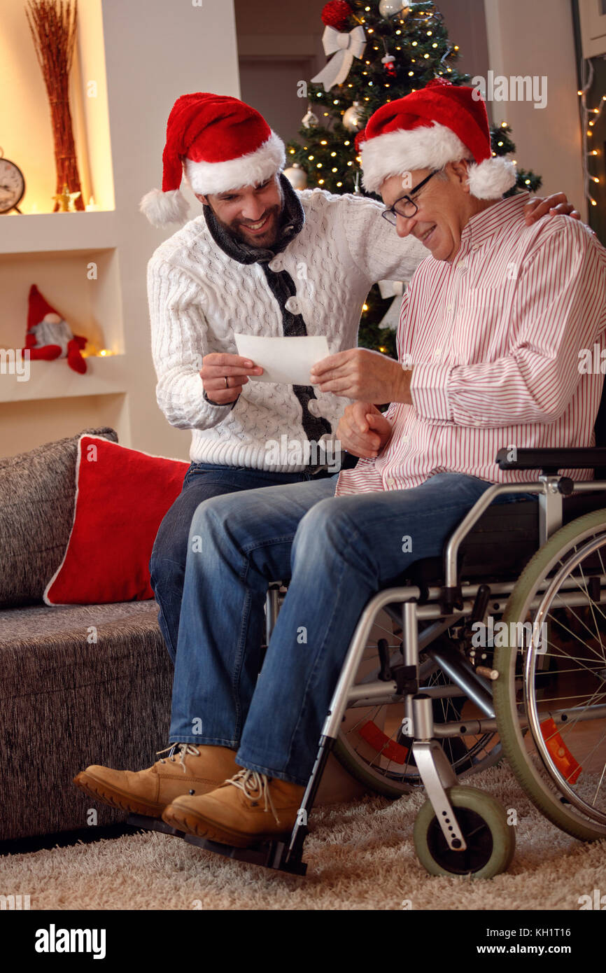 Happy son and his elderly father watching photo and share memory on ...
