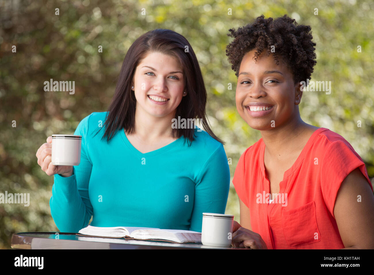 Happy friends reading, praying and learning together Stock Photo - Alamy
