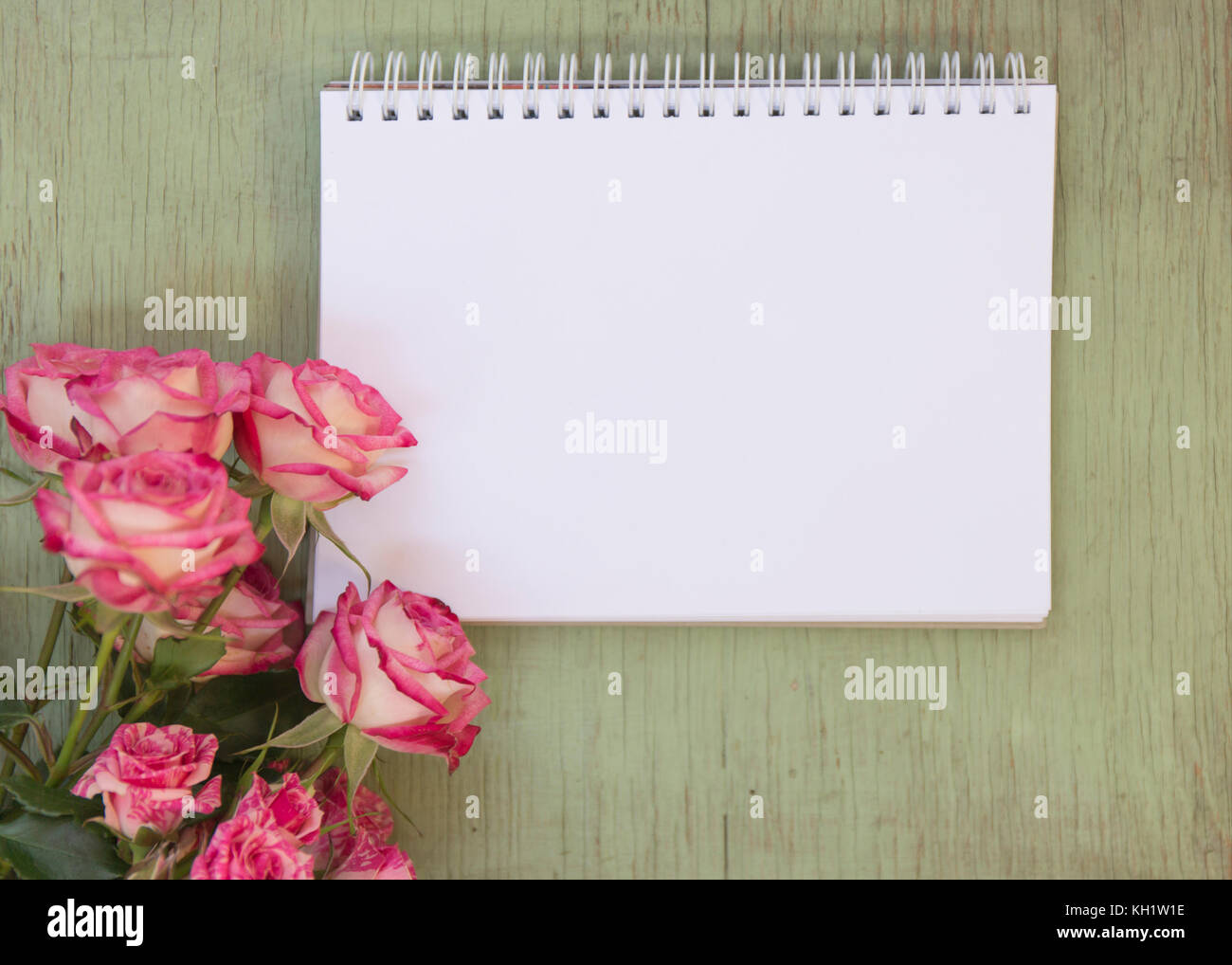 Blank notebook mock up for artwork with pink roses. Place for text ...
