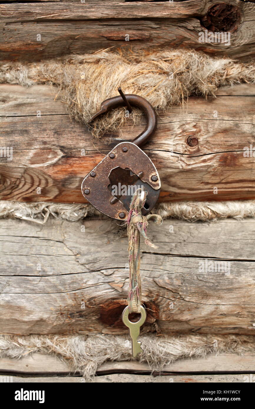 old padlock with key on a background of a timber wall Stock Photo - Alamy