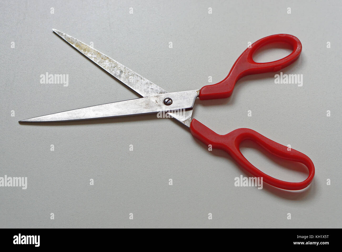 Long scissors with sharp edge and red handles Stock Photo - Alamy