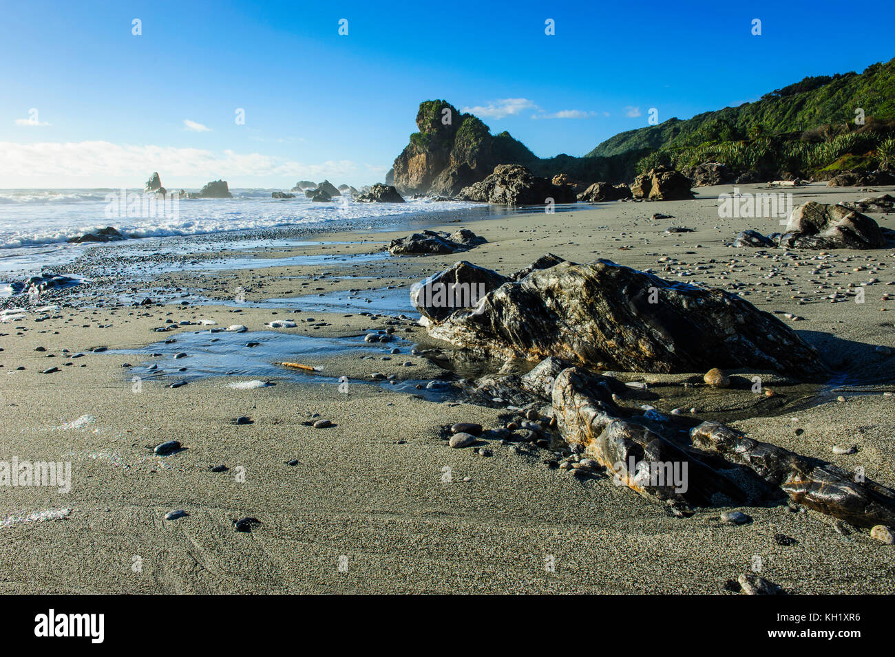 Huge rocks on a sandy beach on the wild west coast of South island ...