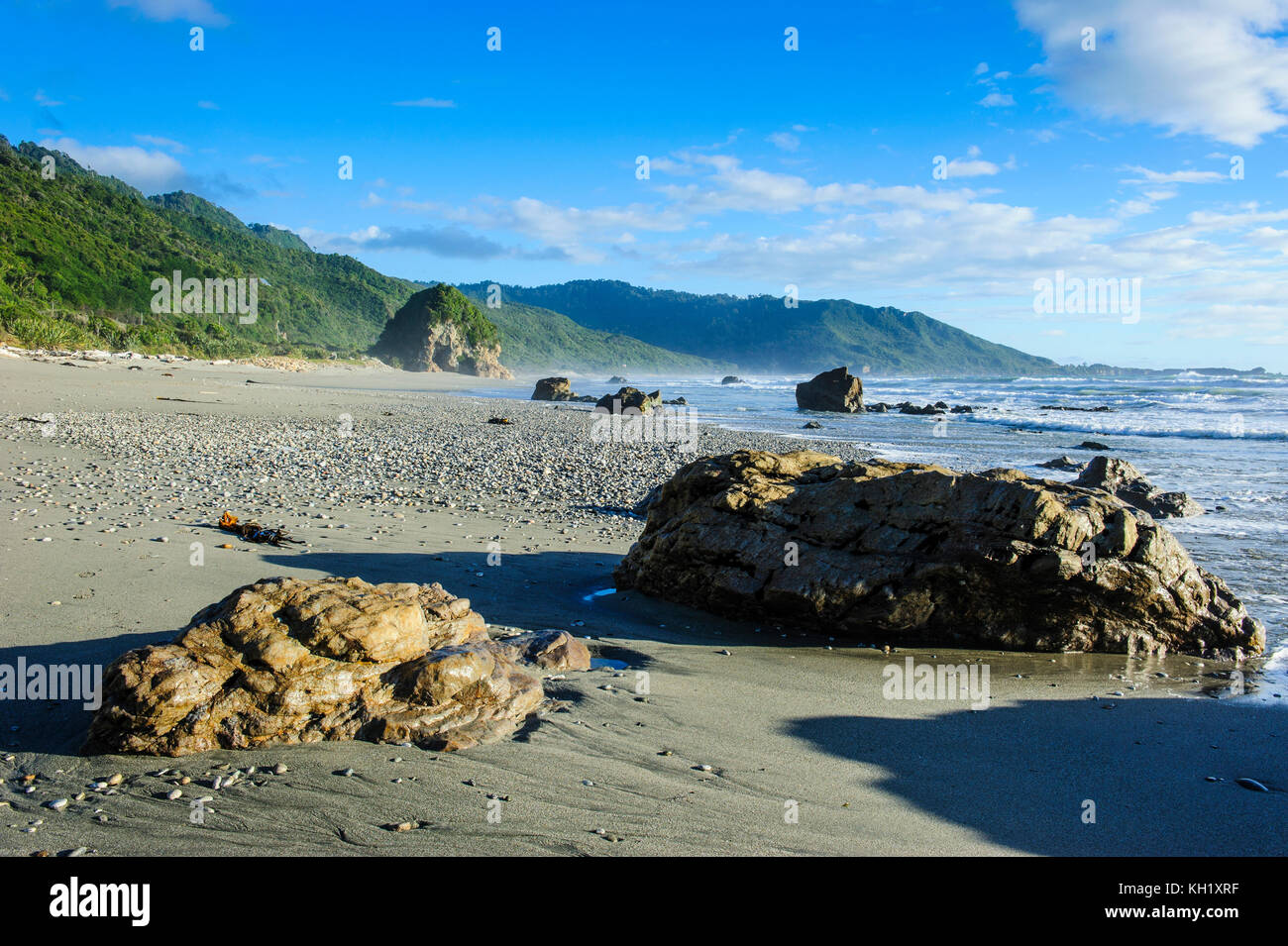 Huge rocks on a sandy beach on the wild west coast of South island ...