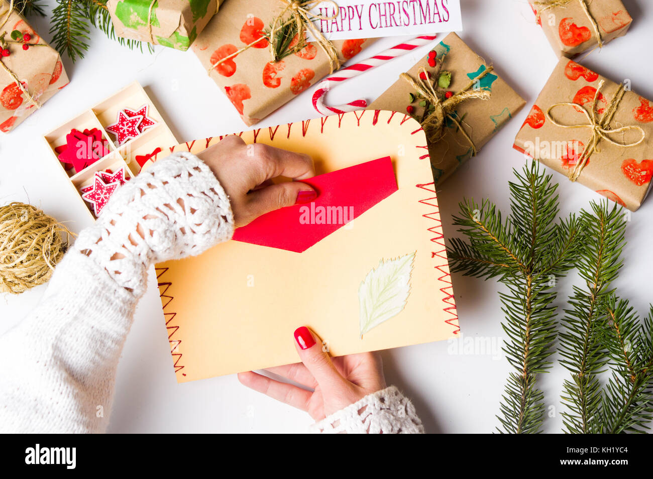 Woman preparing Christmas card point of view Stock Photo - Alamy
