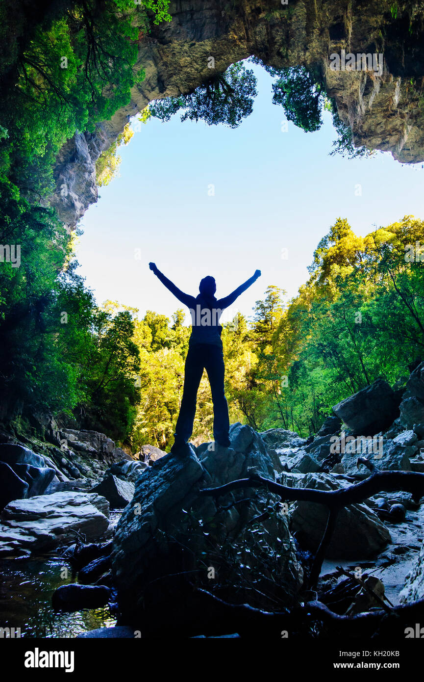 Woman enjoying the stunning Oparara arch in the Oparara Basin, Karamea ...