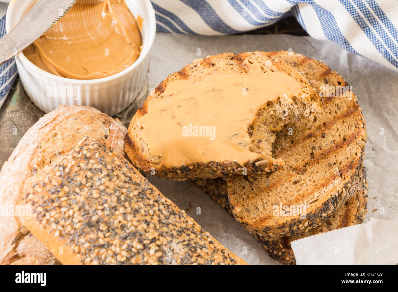 Bitten whole wheat grilled bread slice with peanut butter Stock Photo ...