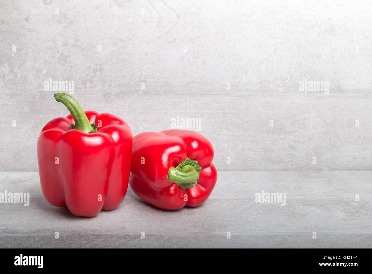 red paprika isolated on a grey background Stock Photo - Alamy