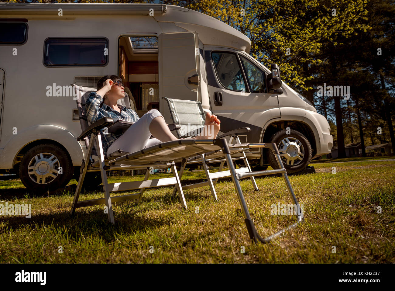 Woman resting near motorhomes in nature. Family vacation travel ...