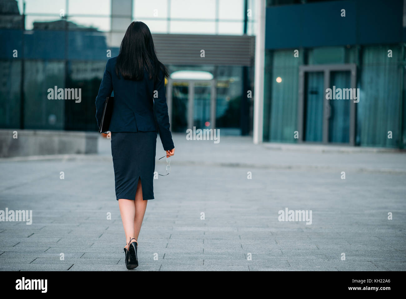 Business woman with laptop in hands, back view Stock Photo - Alamy