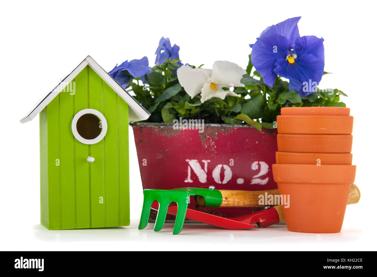 Pansy flowers and other gardening objects isolated over white ...