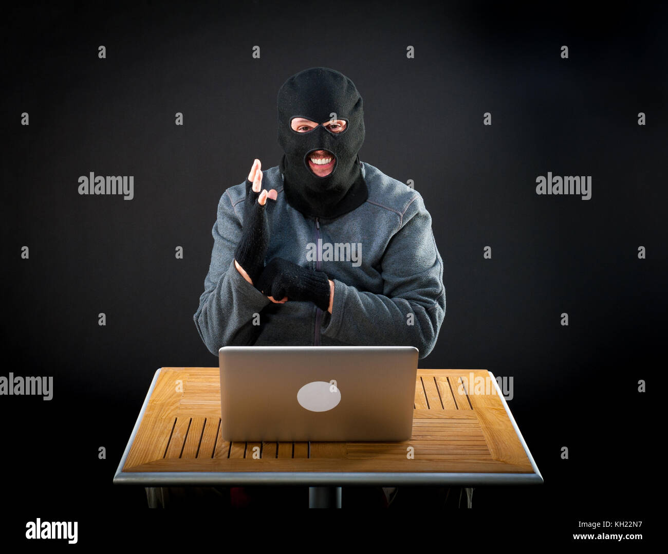 Cheerful hacker is ready to start hacking laptop Stock Photo - Alamy