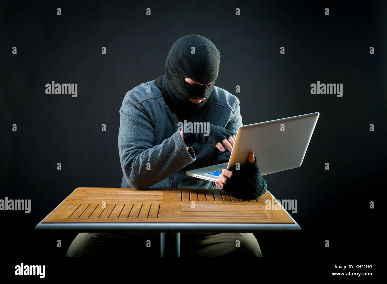 Hacker at work on black background Stock Photo - Alamy