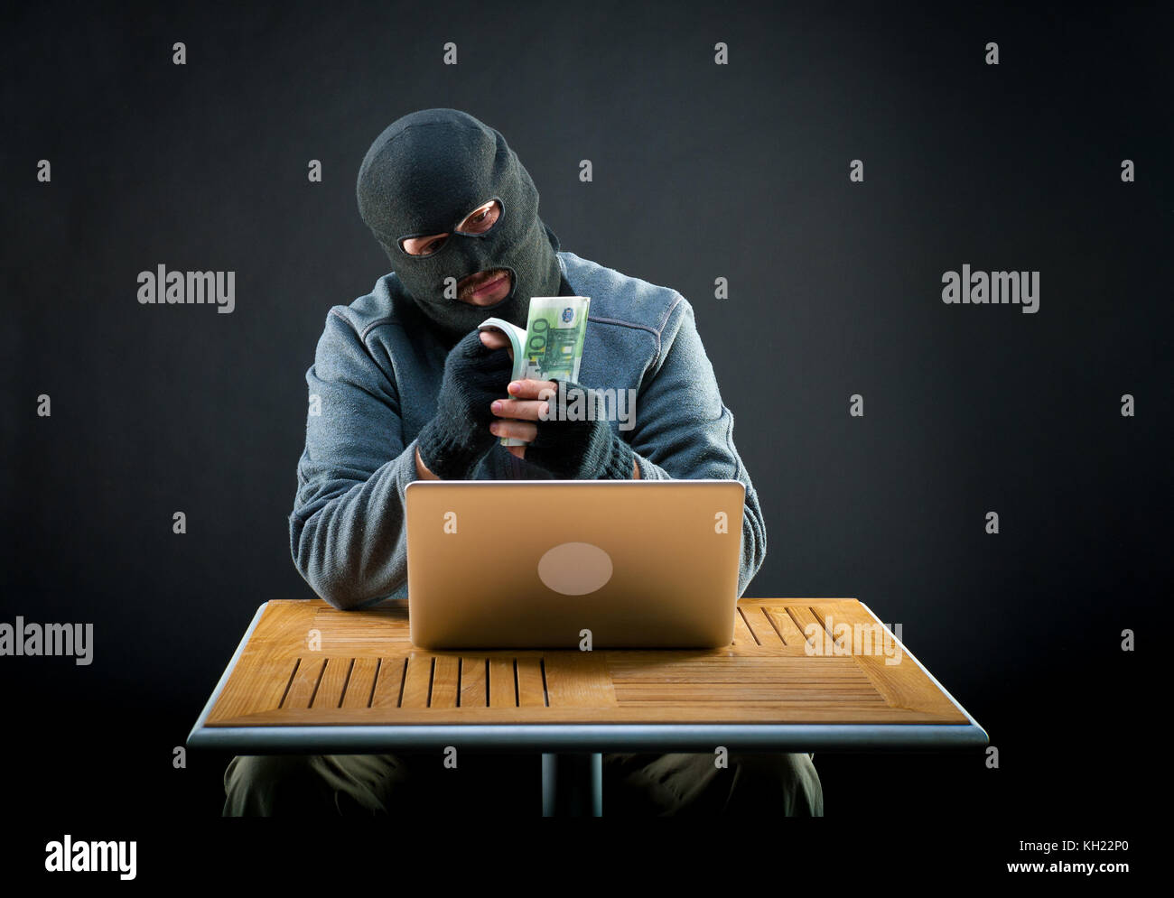 Cybercriminal man counts euro Stock Photo - Alamy