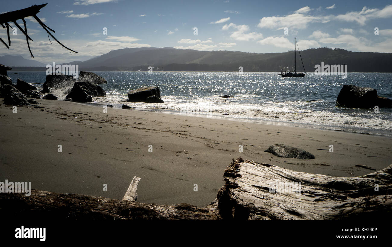 A lone boat ankered in the glittering San Juan Strait. Seen from ...