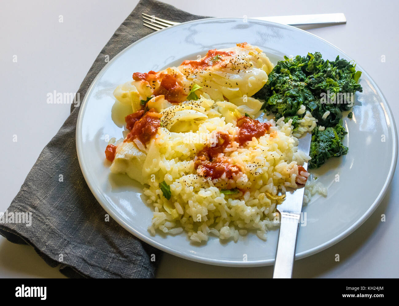 Grilled cod with spinach and rice Stock Photo - Alamy