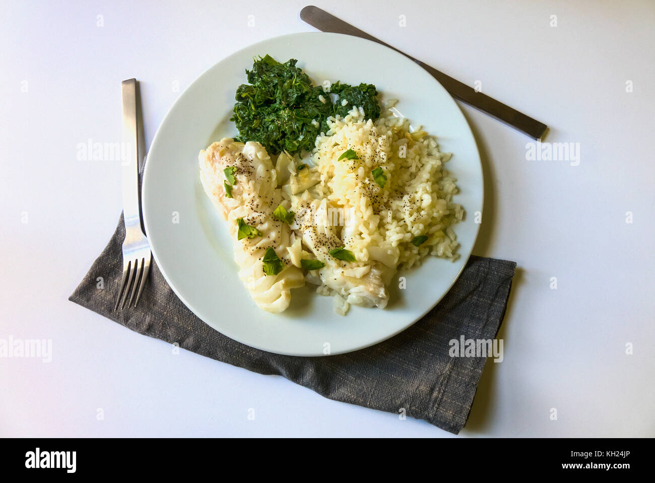 Grilled cod with spinach and rice Stock Photo - Alamy