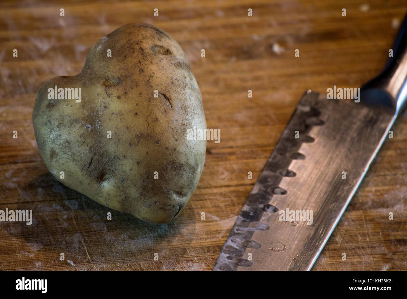 Heart shape potato with knife Stock Photo - Alamy
