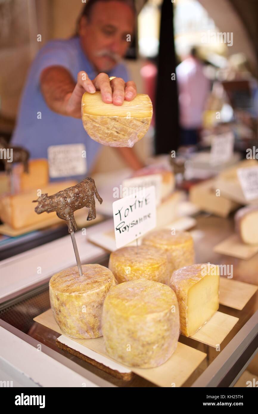Man holding cheese, European market Stock Photo - Alamy