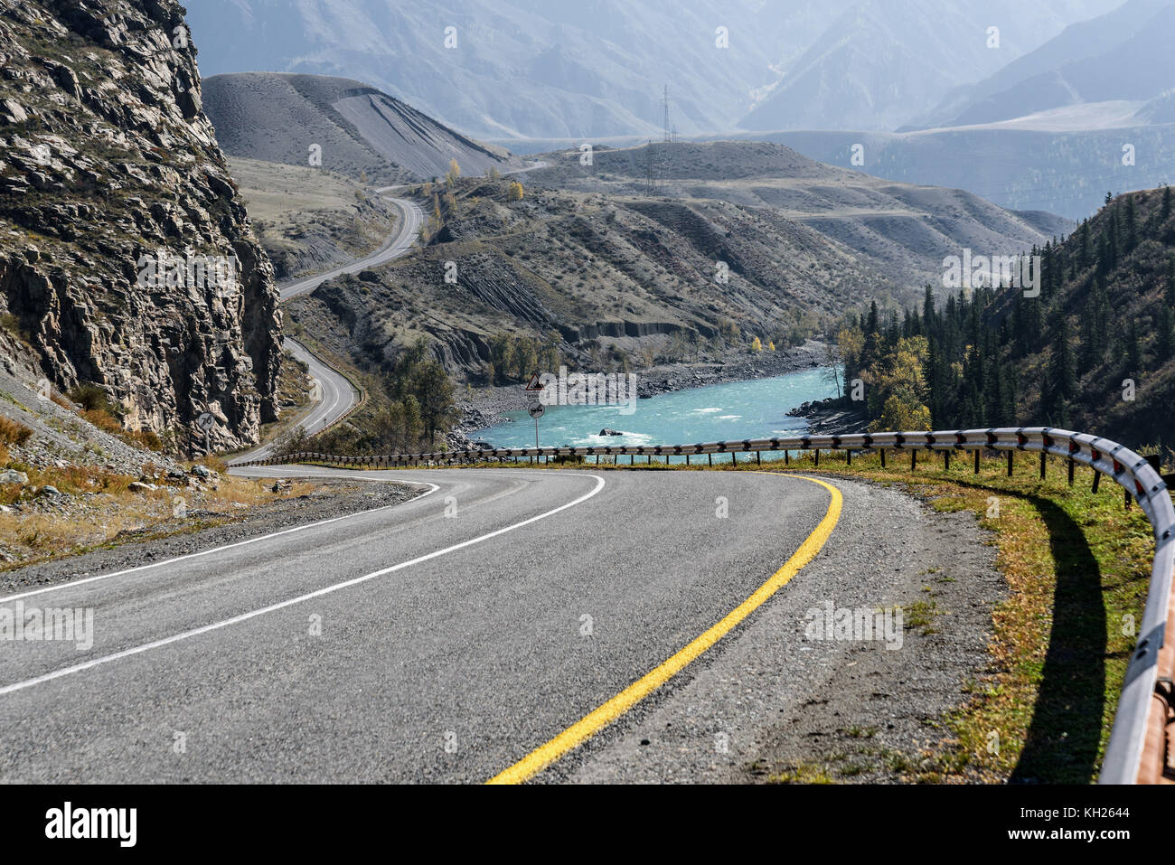Scenic autumn view of the winding asphalt road along the river, the ...