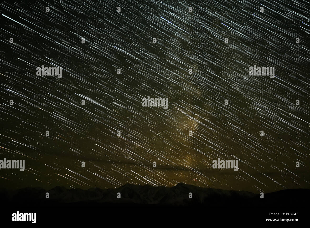 Beautiful night view of the starry sky with traces of falling stars in ...