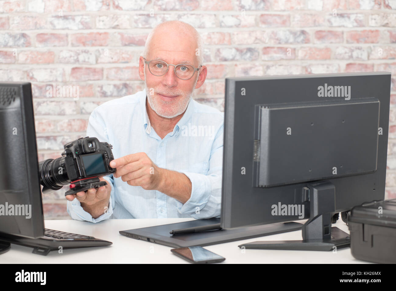man photographer and camera at office with computer Stock Photo - Alamy