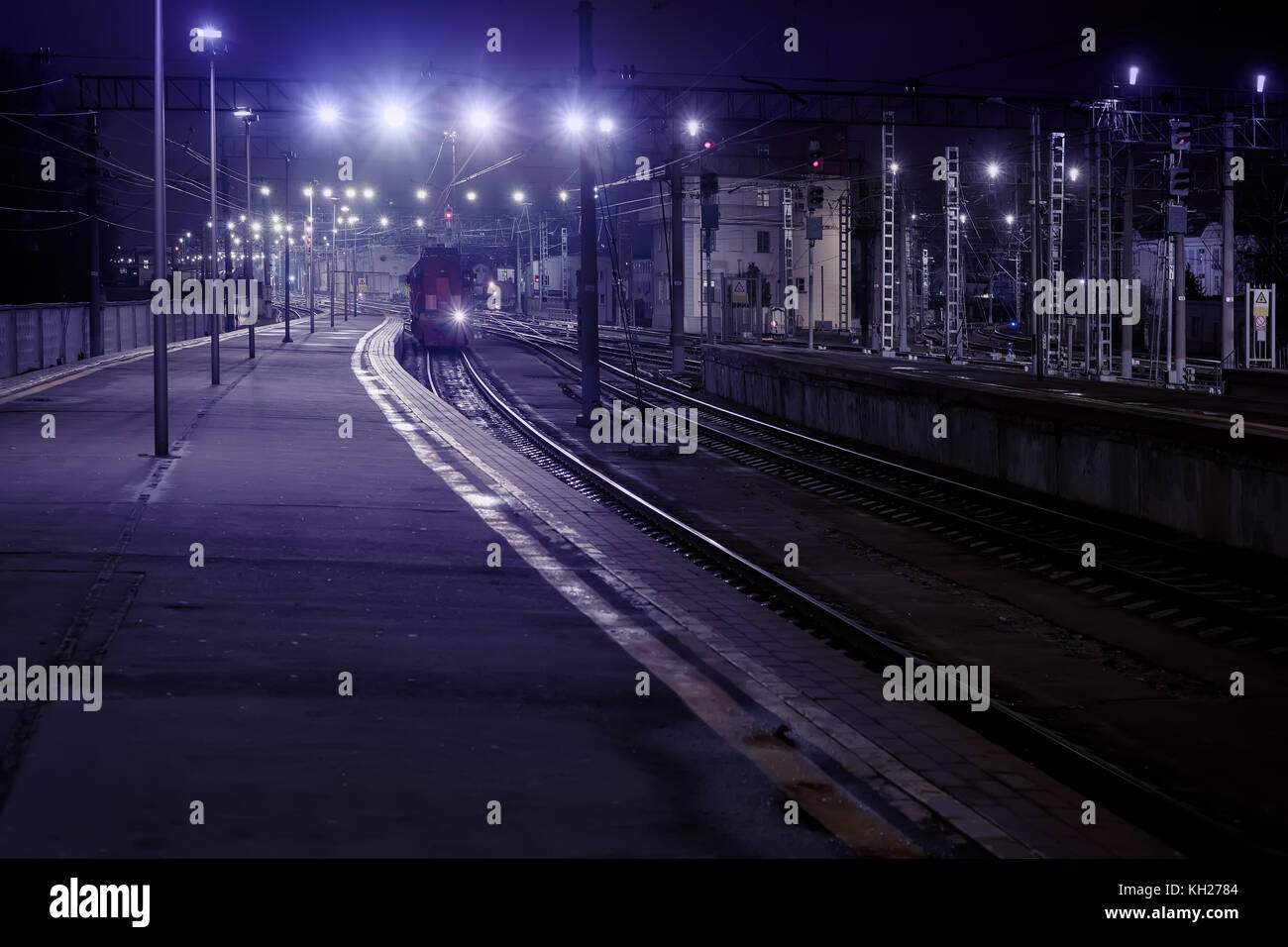 Lights on railway station. Night scene. Blue toned image Stock Photo ...