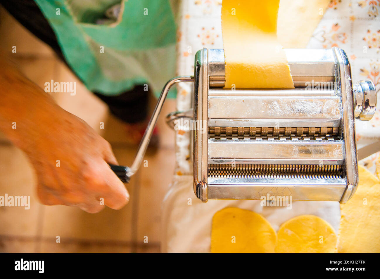grandma using old machine to make pasta the old way Stock Photo - Alamy
