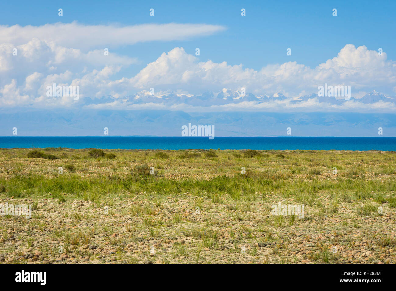 Blue scenic Karakol Lake with the mountains behind, Kyrgyzstan Stock ...