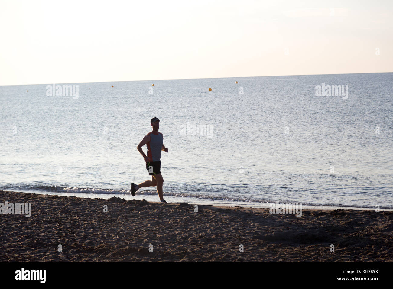 lonely runner at the beach Stock Photo - Alamy