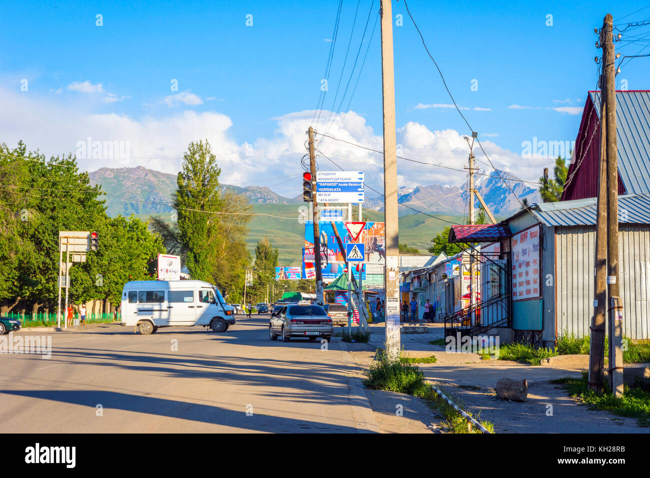 KARAKOL, KYRGYZSTAN - AUGUST 2: View over the street with cars and ...