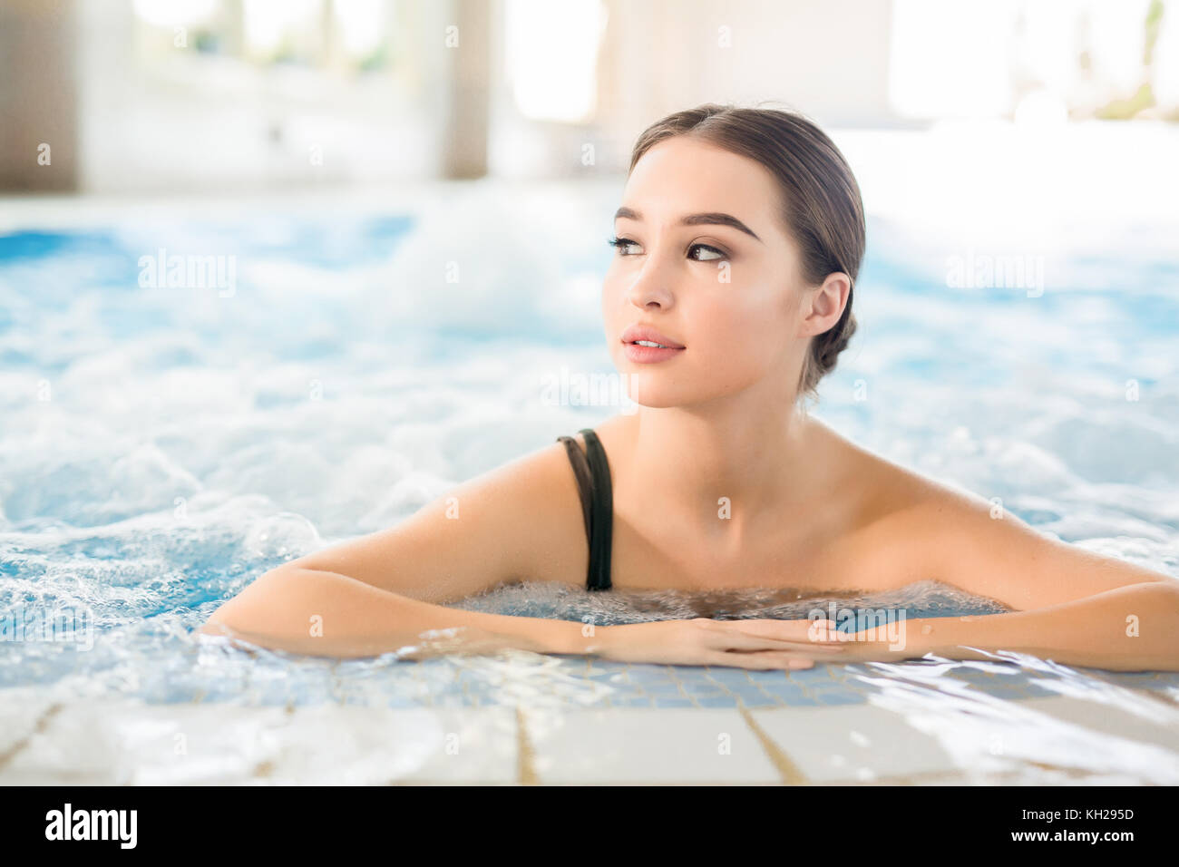 Serene woman in bikini enjoying warm water waves at spa resort Stock ...