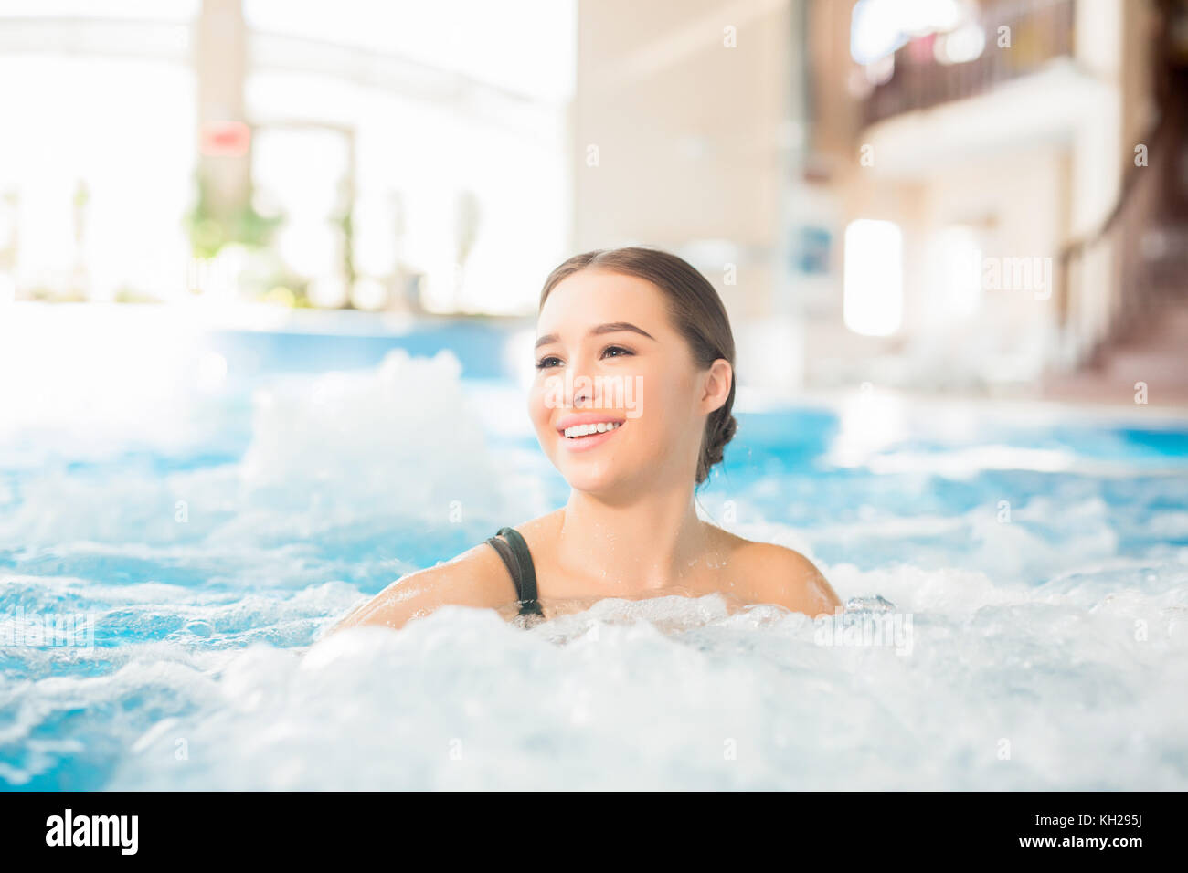 Young beauty in whirlpool enjoying pleasant and warm waves Stock Photo ...