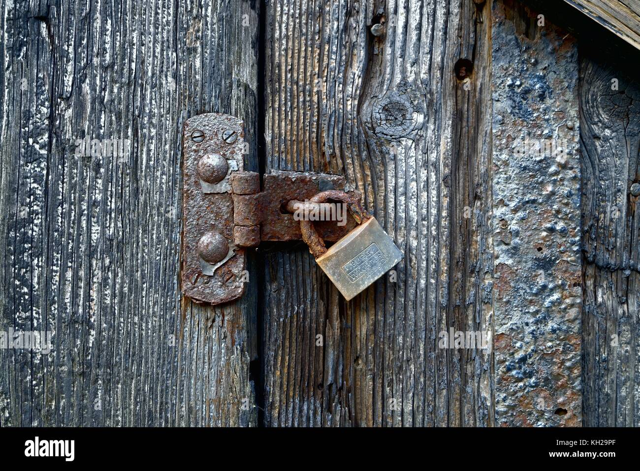 Close up of a rusty lock on old wooden door Stock Photo - Alamy