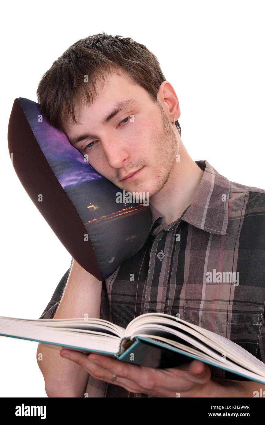 Student falls asleep from exhaustion while reading a textbook Stock ...
