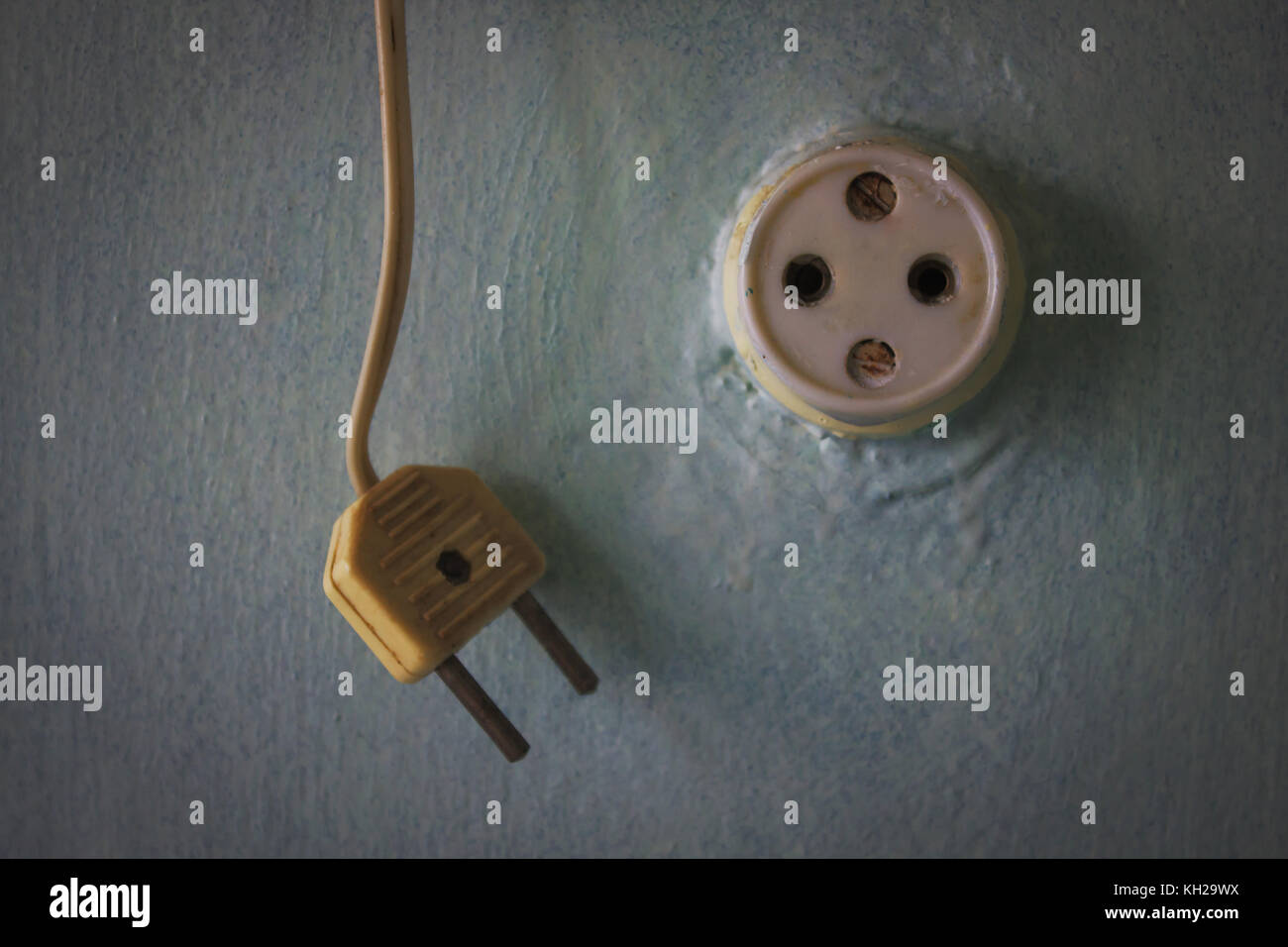 Vintage plug on the wire hangs next to the old socket Stock Photo - Alamy