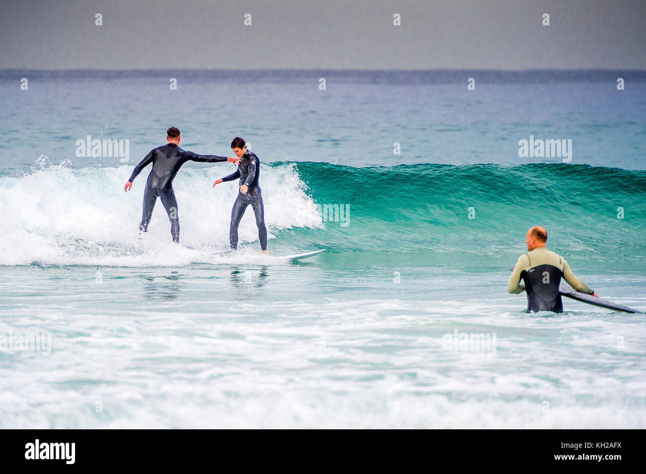 Two surfers fight wave hi-res stock photography and images - Alamy