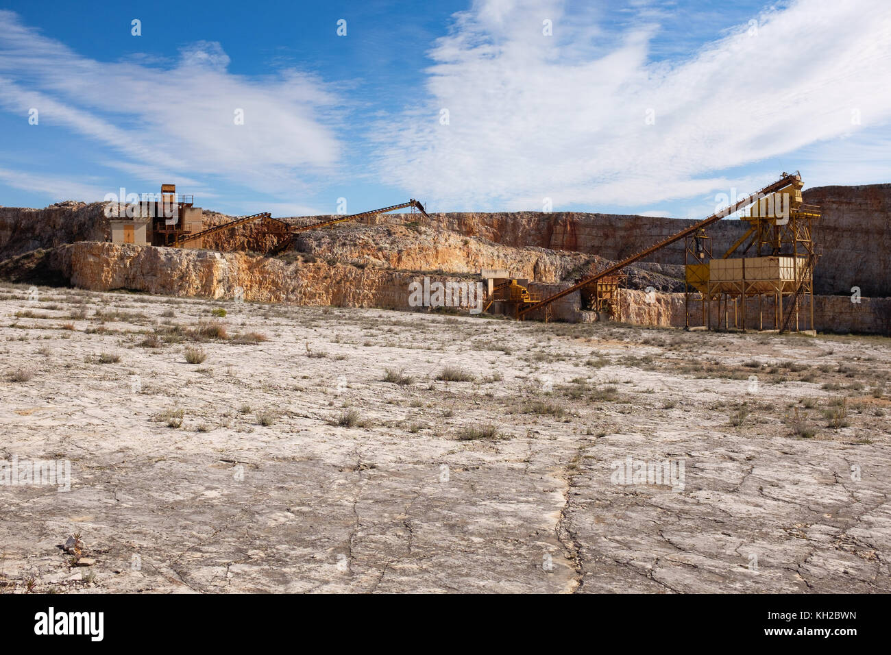 Former stone quarry with abandoned crusher and conveyor machines ...