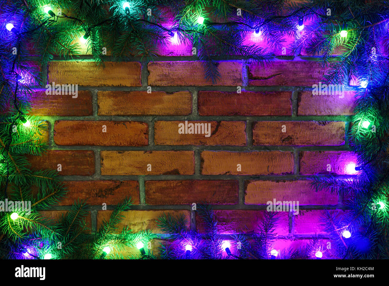 Wreath and garlands of colored light bulbs.Christmas background with ...