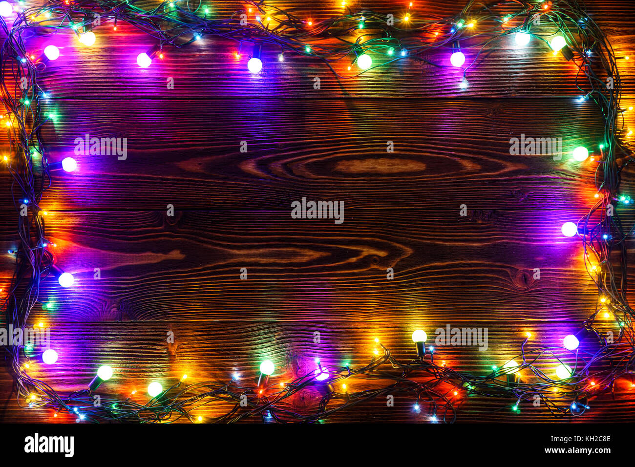 Wreath and garlands of colored light bulbs.Christmas background with ...