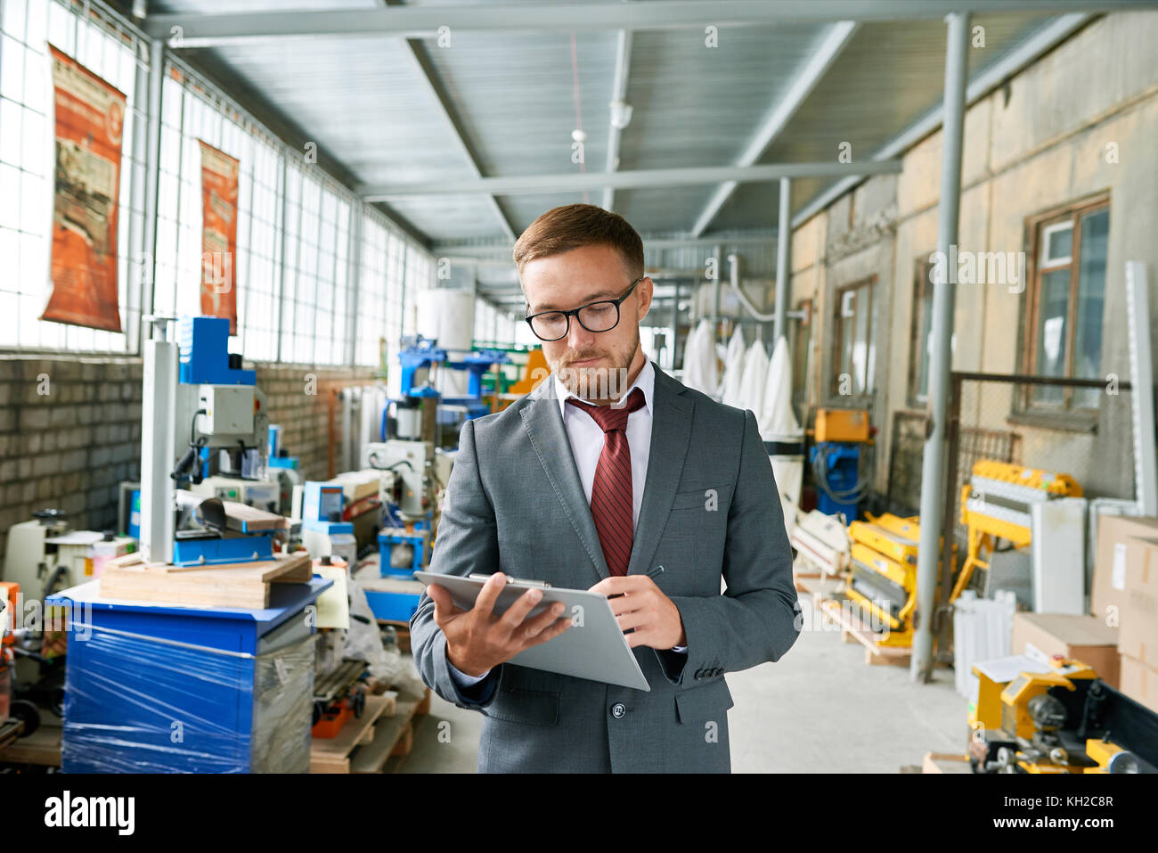 Portrait of successful sales assistant wearing suit posing looking at ...