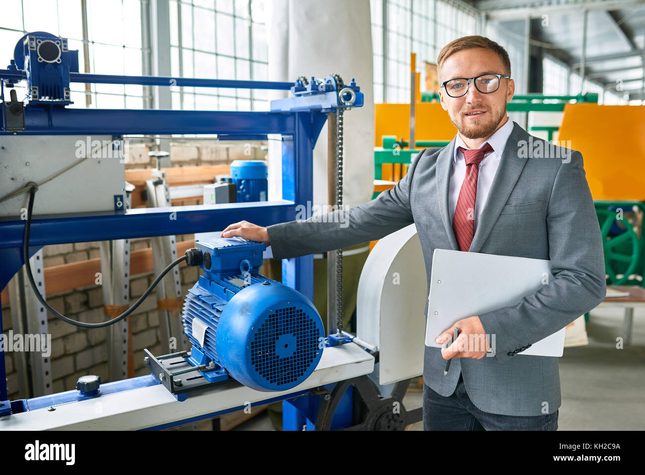 Portrait of successful salesman wearing suit posing looking at camera ...