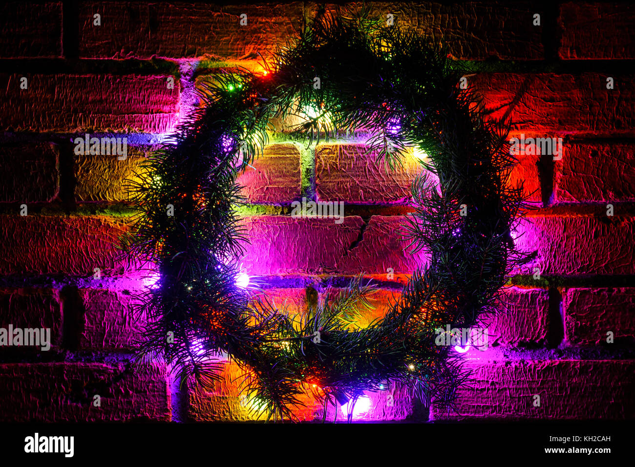 Wreath and garlands of colored light bulbs.Christmas background with ...