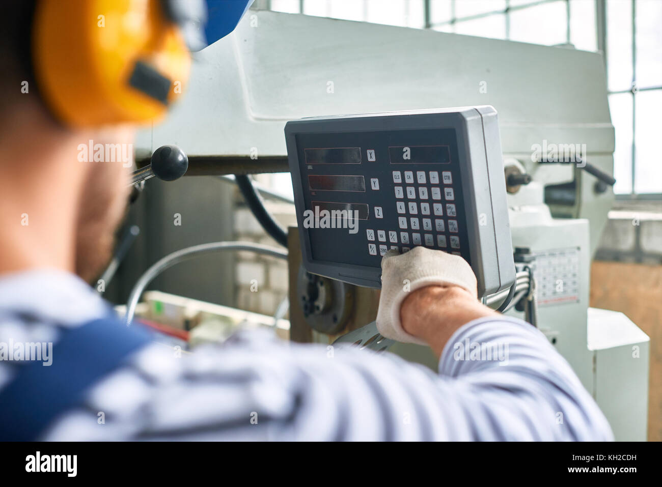 Closeup of worker pushing buttons on electronic control panel while ...