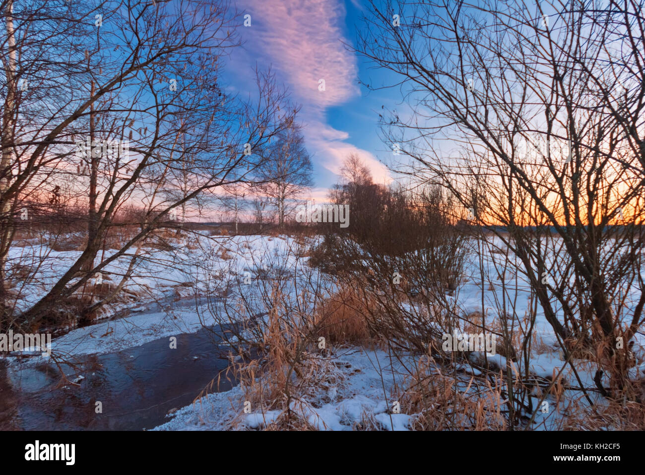Winter sunset in winter field with small river Stock Photo - Alamy