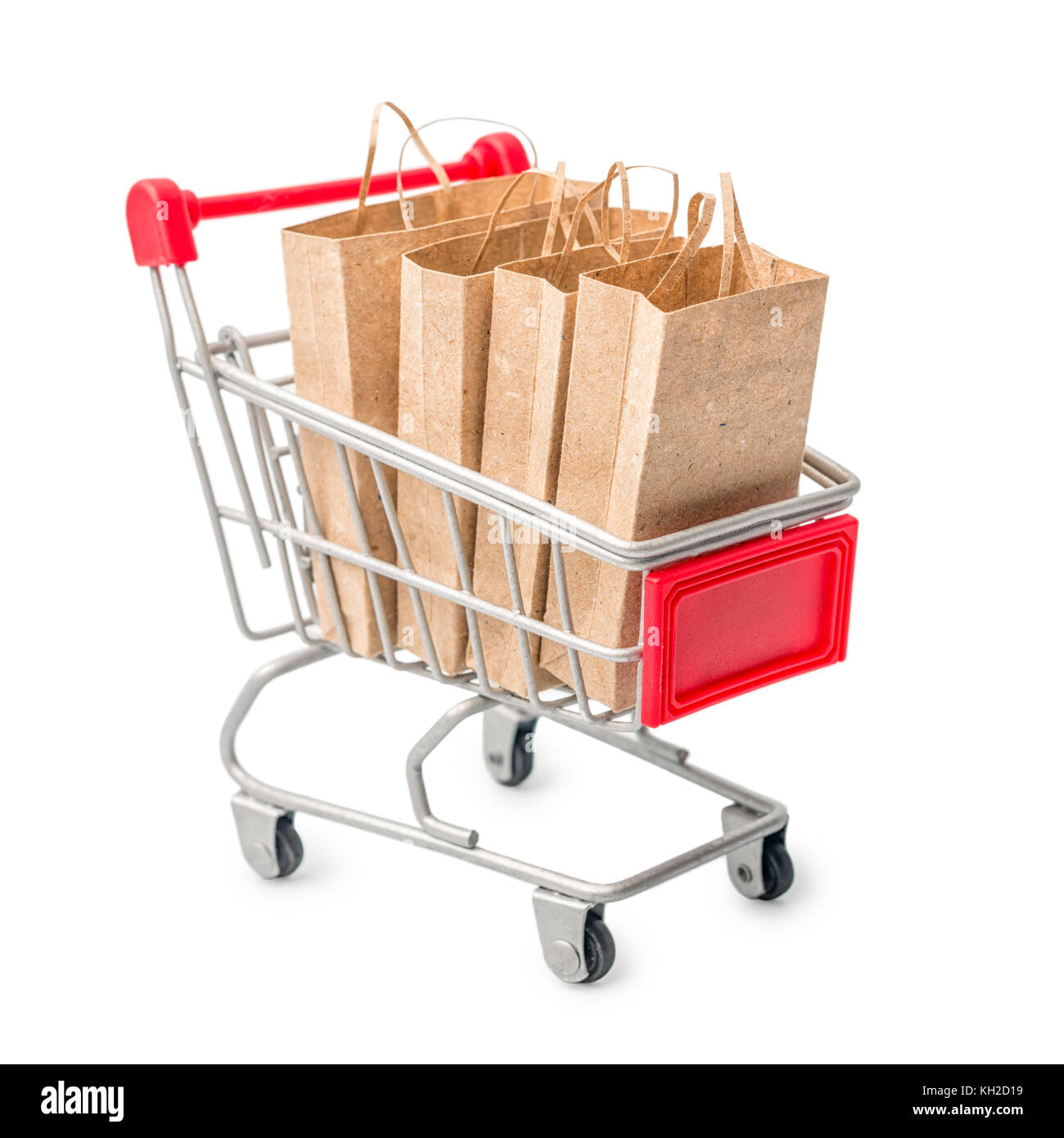 metal shopping cart with craft paper bag isolated on white background ...