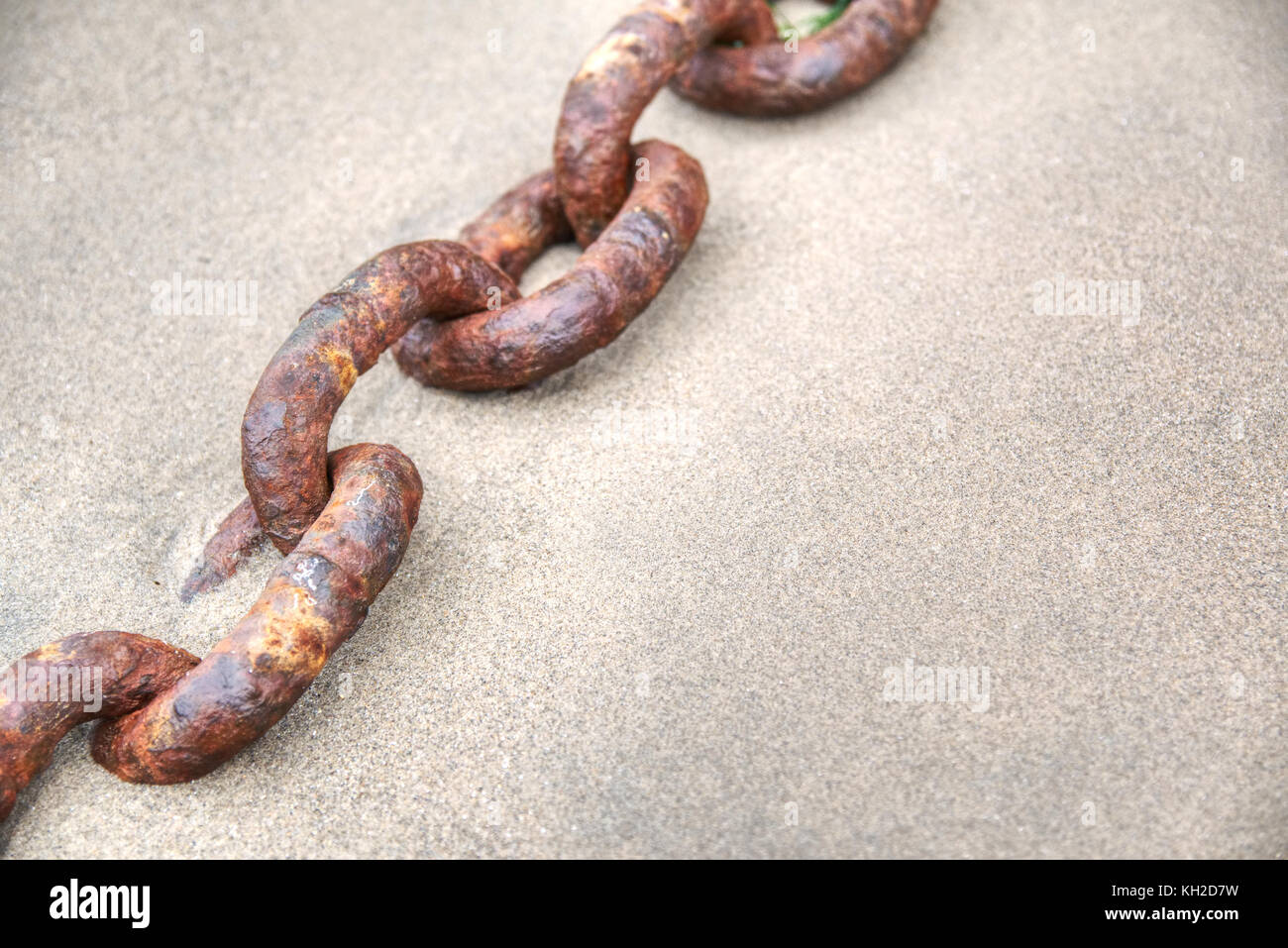 Rusty old boat chain on a sandy beach with room for copy Stock Photo ...