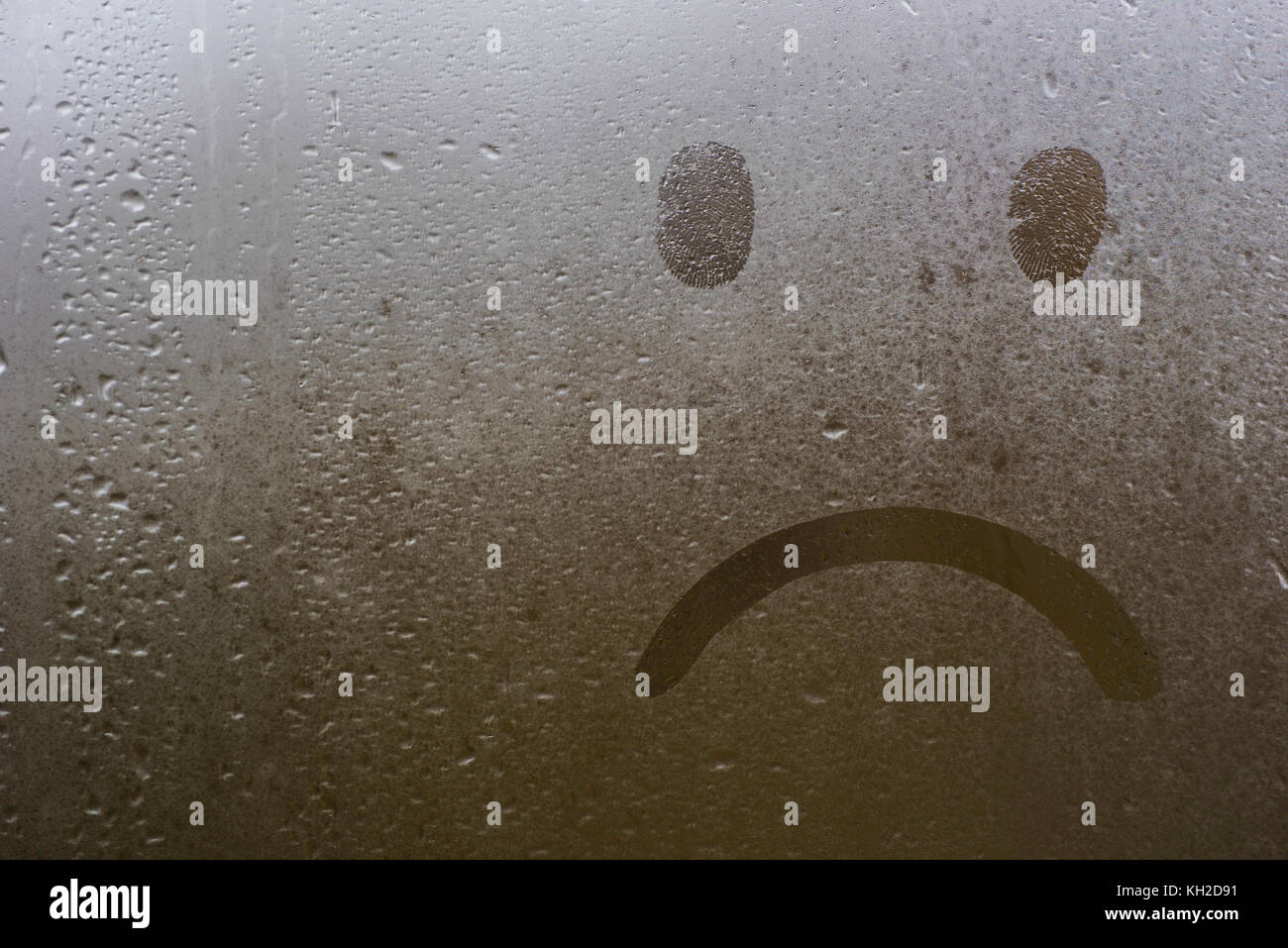 sad face on a wet window glass in the autumn Stock Photo - Alamy